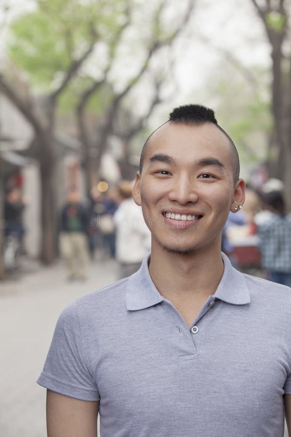 Young Man with Mohawk Haircut Smiling Looking at Camera Stock Photo ...