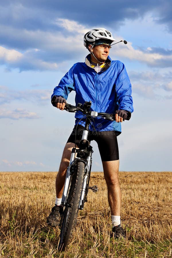 Young Man Standing with Mountain Bike Against Hills Stock Image - Image ...