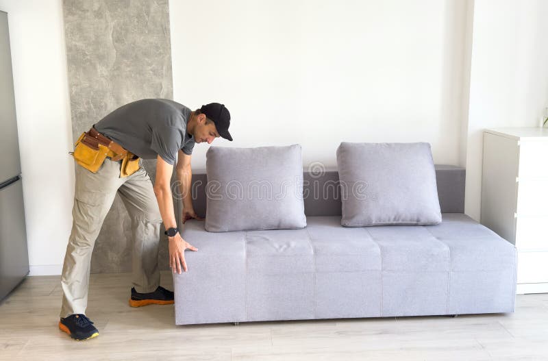 Young Man Moving Sofa Couch Stock Photo - Image of heavy, effortful ...