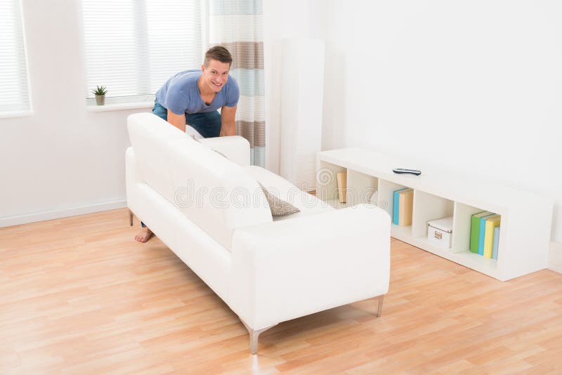 Young Man Moving Sofa stock photo. Image of individuality - 58558078