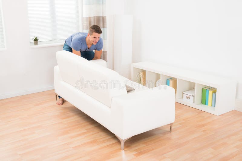 Young Man Moving Sofa stock photo. Image of modern, effort - 58874110