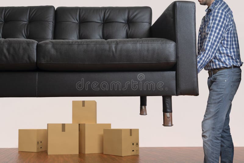 Young Man is Moving Sofa. Moving To a New House Concept. Stock Photo ...