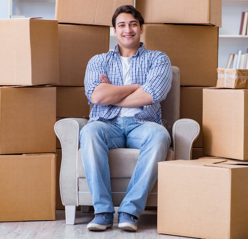 Young Man Moving in To New House with Boxes Stock Image - Image of ...