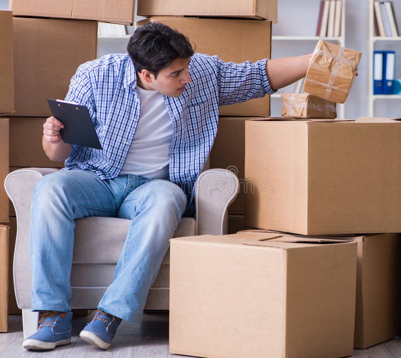 Young Man Moving in To New House with Boxes Stock Image - Image of ...