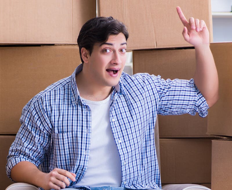 The Young Man Moving in To New House with Boxes Stock Image - Image of ...