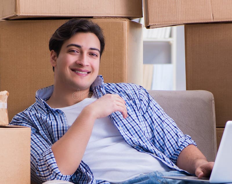 Young Man Moving in To New House with Boxes Stock Photo - Image of ...