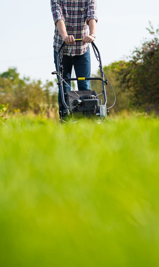 Young man mowing the grass stock image. Image of gardener - 78566099