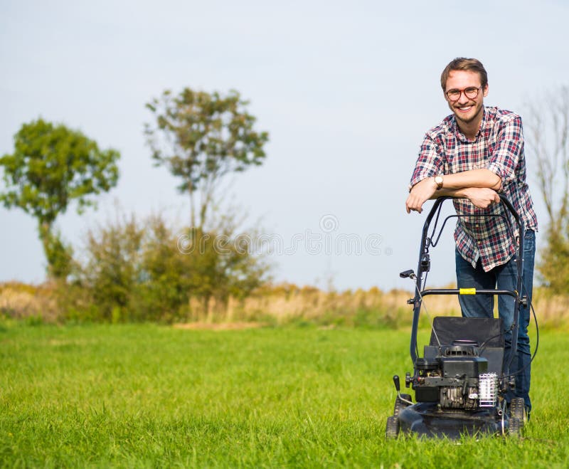 Young man mowing the grass stock image. Image of mowing - 78566655