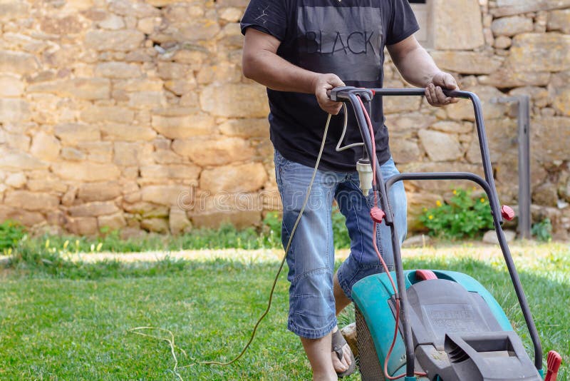 Young Man Mowing the lawn stock photo. Image of working - 77980428