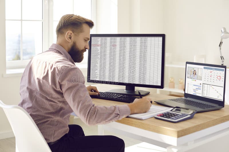 Accountant Multitasking while Working with Data on Computers at His ...