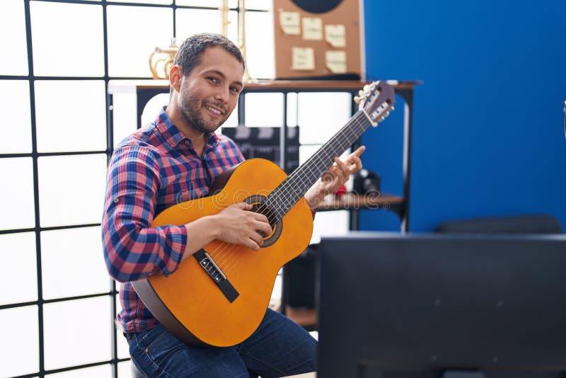 Young Man Musician Smiling Confident Playing Classical Guitar at Music ...