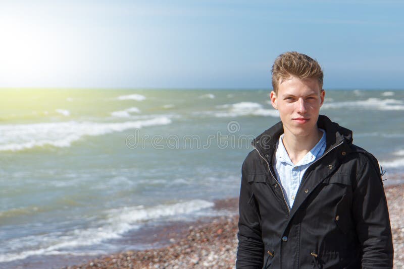 Young man near sea stock image. Image of shore, beach - 101661805
