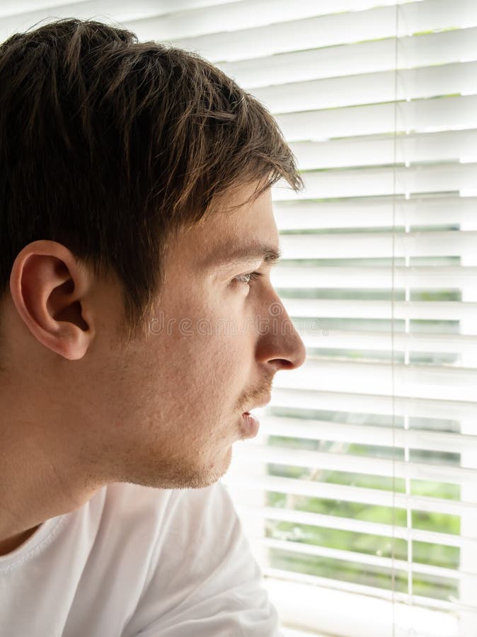Young Man near the Window stock image. Image of upset - 254496157