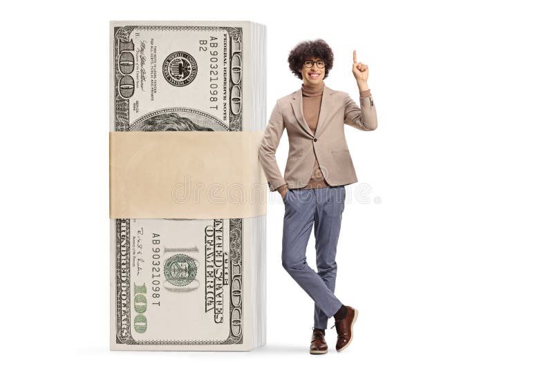 Young Man Next To a Stack of Money Standing and Pointing Up Stock Photo ...
