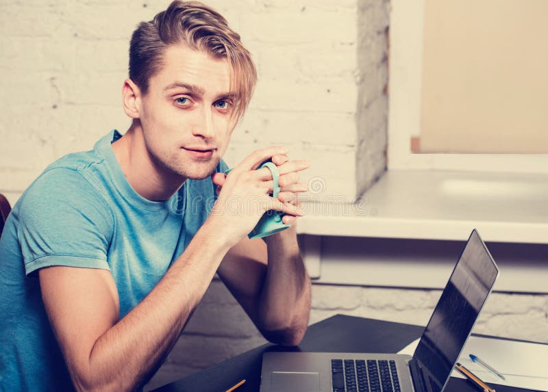 Young Man with Notebook Laptop Working on Work Place Looking Camera ...