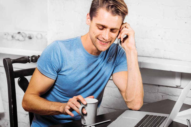 Young Man with Notebook Laptop Working on Work Place Talking Mobile ...
