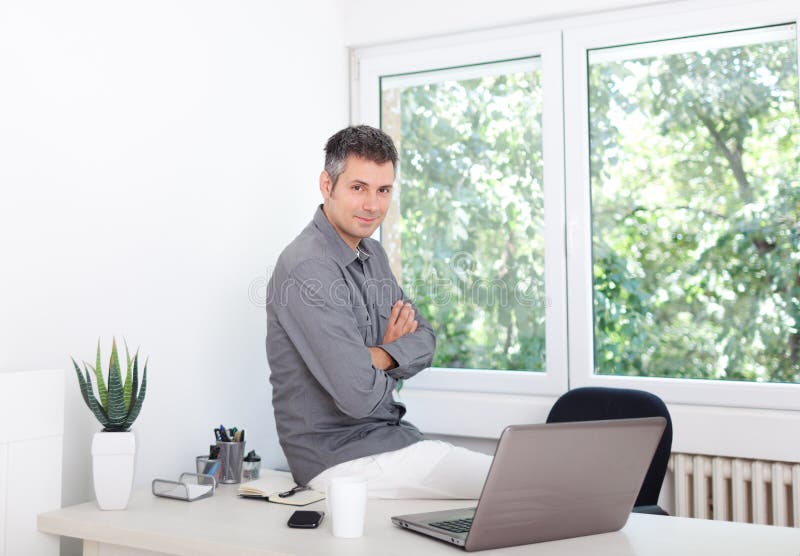 Young Man at Office Desk, Working on Laptop Stock Photo - Image of grey ...