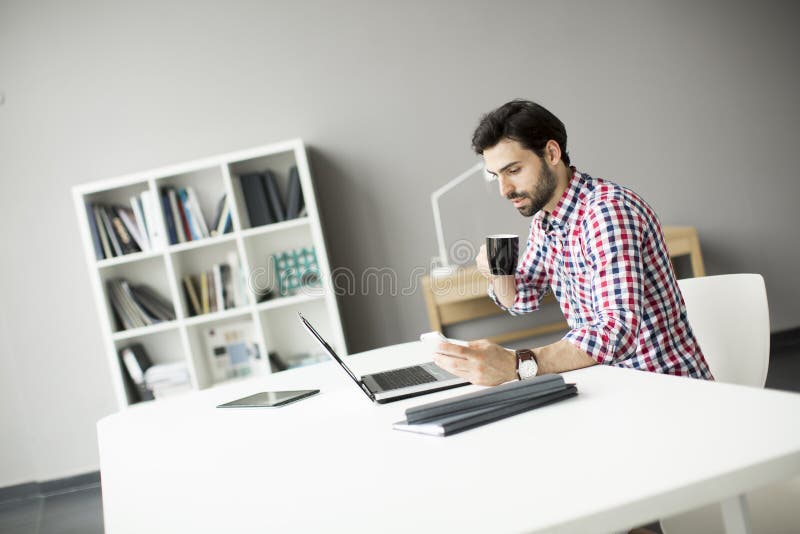 Young man at the office stock image. Image of casual - 65093933
