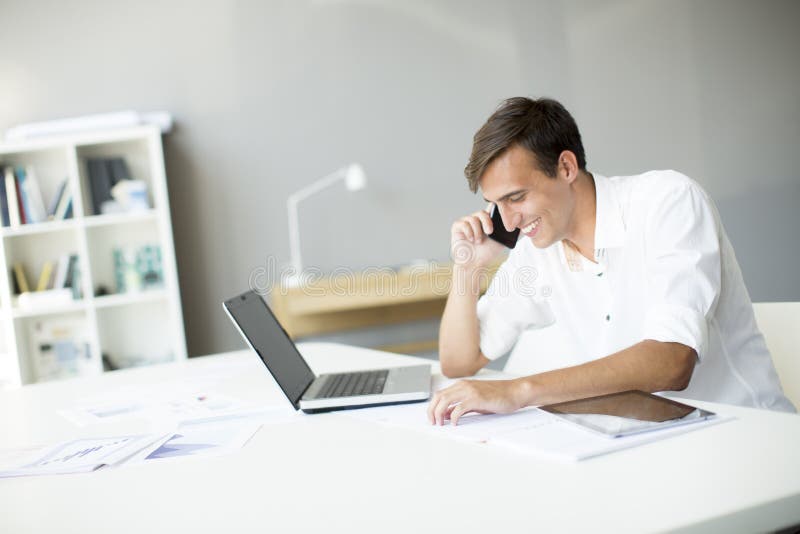 Young man in the office stock photo. Image of office - 65429658