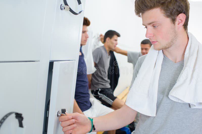 Young man in locker room stock image. Image of university - 101911781