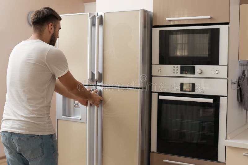 Young Man Opening Refrigerator Doors Stock Photo - Image of adult, cook ...