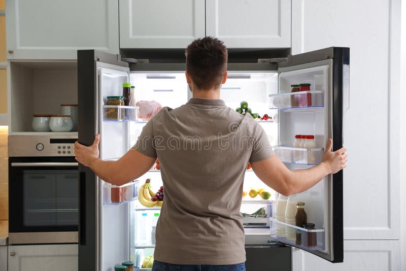 Man Opening Refrigerator in Kitchen, Back View Stock Photo - Image of ...