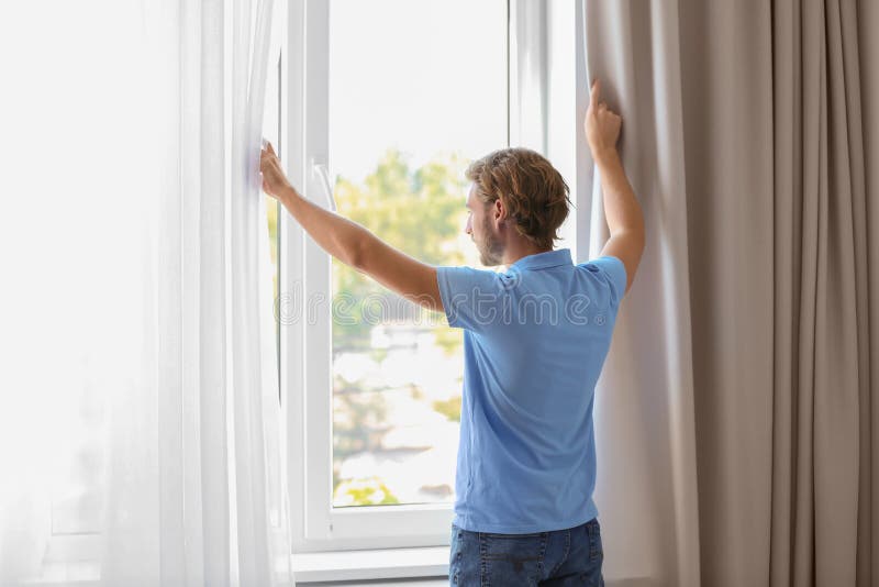 Young Man Opening Window Curtains Stock Photo - Image of beauty ...