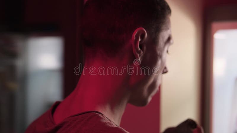 Young Man Opens His Refrigerator To Get Something To Eat. Nighttime ...