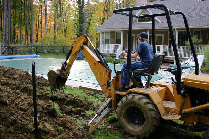 Young Man Operating Backhoe Stock Image - Image of backyard, backhoe ...