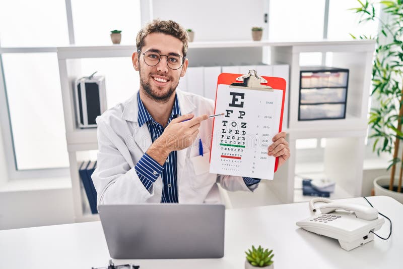 Young Man Optician Holding Snellen Test at Clinic Stock Photo - Image ...