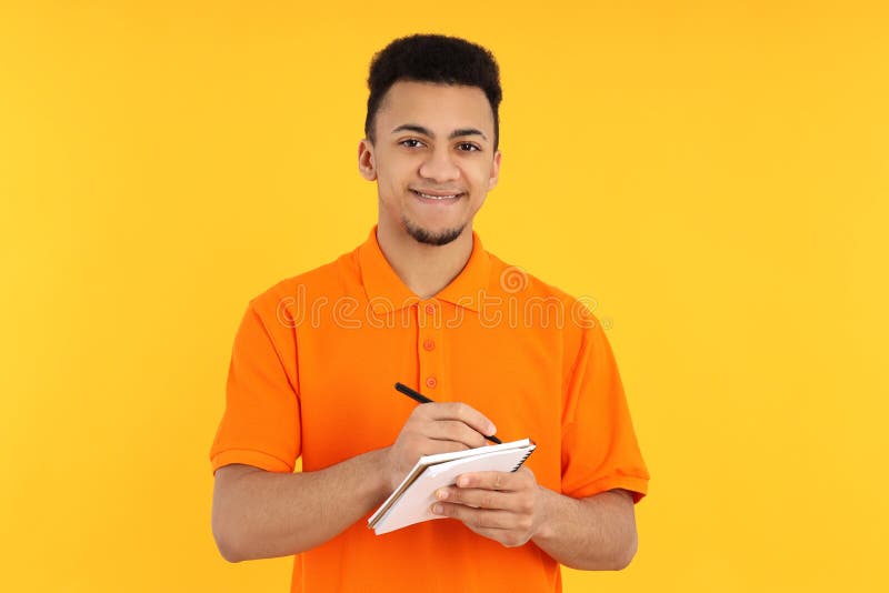 Young Man in Orange Polo on Yellow Background Stock Photo - Image of ...