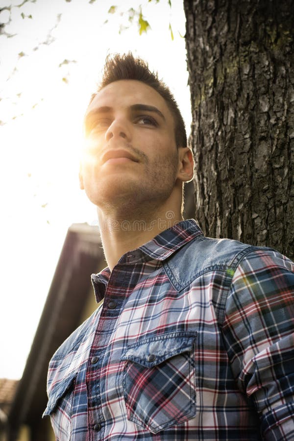 Young Man Outdoors Against a Tree, at Sunset Stock Photo - Image of ...