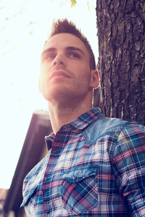 Young Man Outdoors at Sunset, with Sun Behind Him Stock Photo - Image ...