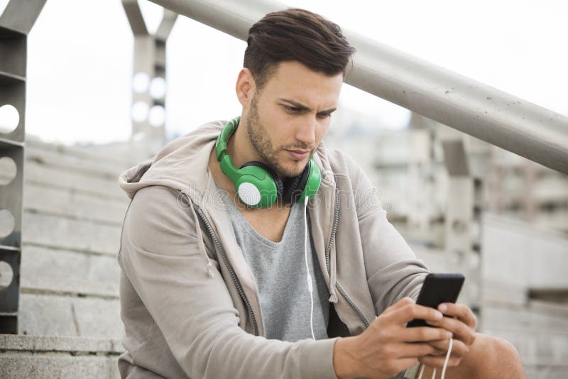 Young Man Outdoors Texting and Looking Worried Stock Image - Image of ...