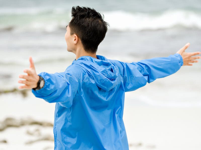 Young Man with Outstretched Arms at the Beach Stock Image - Image of ...