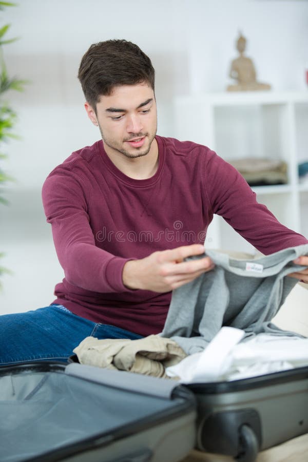 Young Man Packing Bag and Preparing for Traveling Stock Image - Image ...