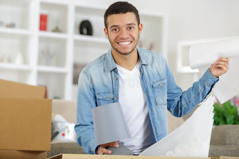 Young man packing box stock photo. Image of male, relocation - 186136800