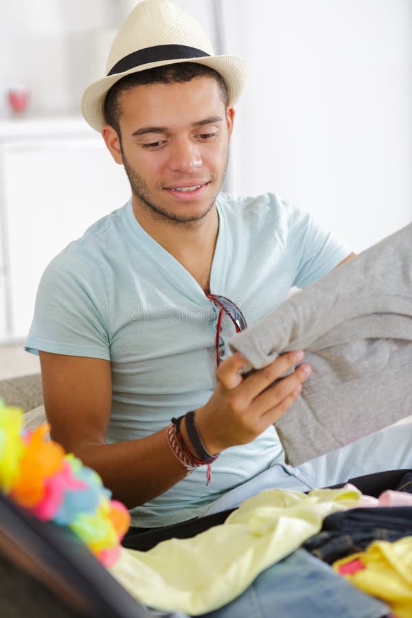 Young man packing suitcase stock image. Image of anticipation - 276720921
