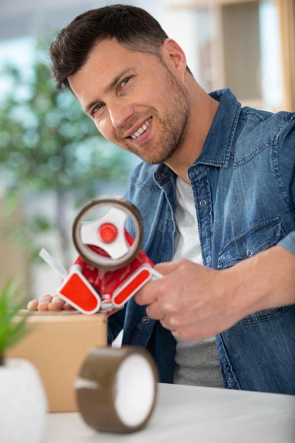 Young Man Packing Things and Taping Boxes Stock Photo - Image of adult ...