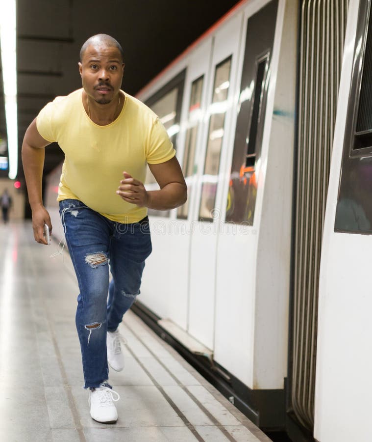 Young Man Passenger Running To Train at Metro Station Platform Stock ...