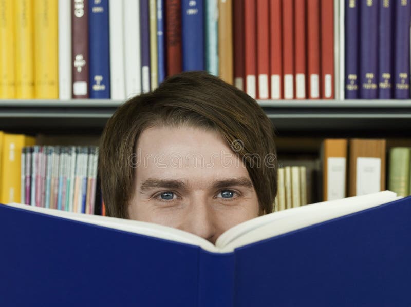 Boy Peeking Over Book stock photo. Image of caucasian - 29662072