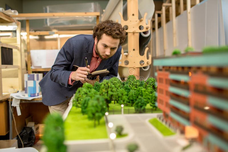 Architects Creating New Project with the Use of Small Model of High ...