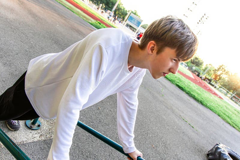 Young Man Performing Dip Exercise on Parallel Bars at Outdoor Gym Stock ...