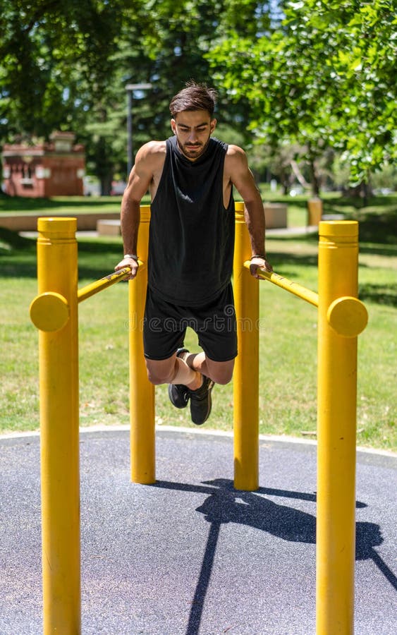 Young Man Performing Dips on Outdoor Parallel Bars Stock Photo - Image ...