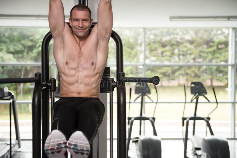 Young Man Performing Hanging Leg Raises Abs Exercise Stock Photo ...