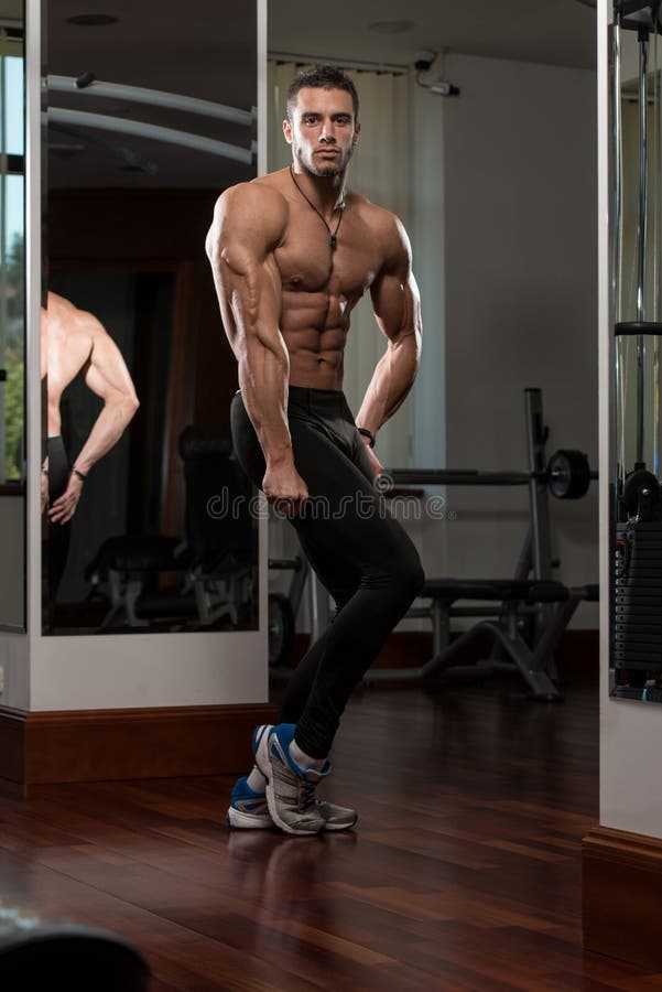 Young Man Performing Side Triceps Pose Stock Photo - Image of muscle ...