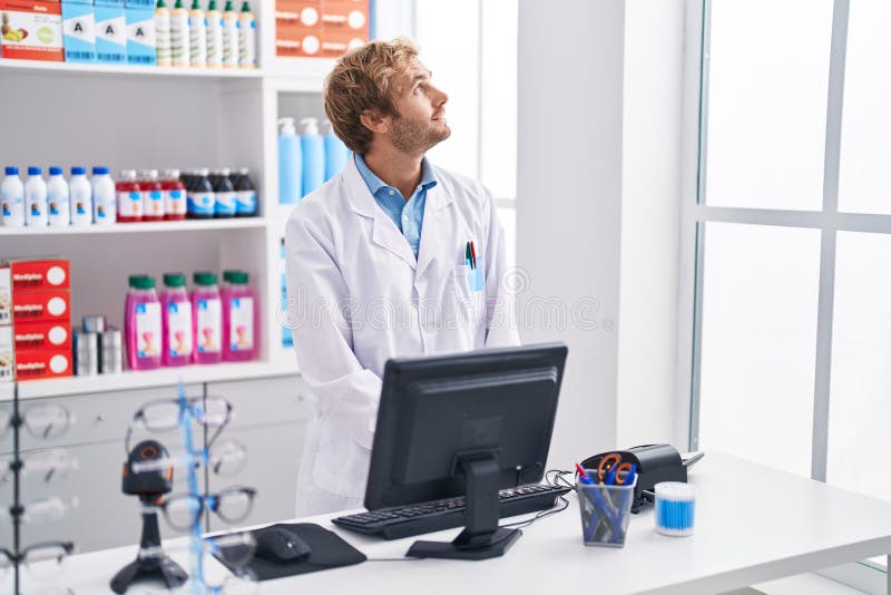 Young Man Pharmacist Using Computer Working at Pharmacy Stock Image ...