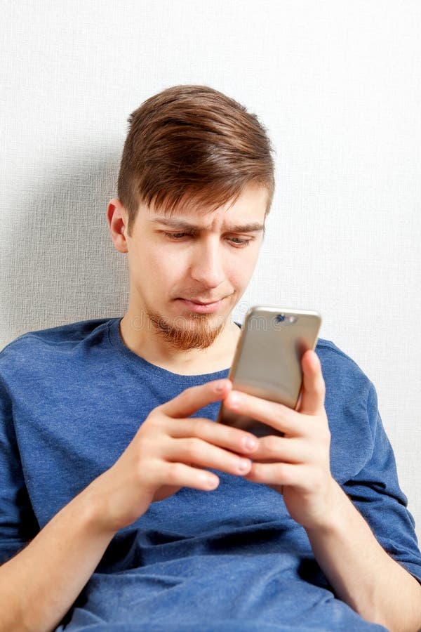 Young Man with a Phone stock photo. Image of smartphone - 194476398