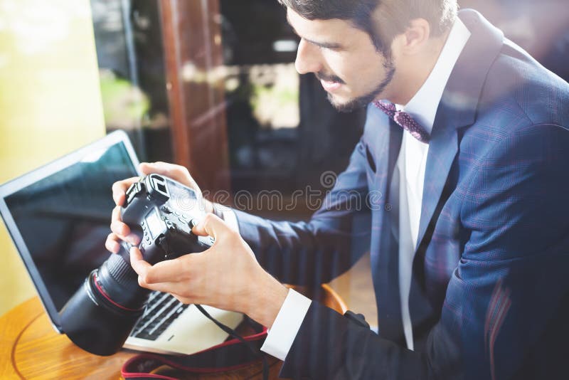 Young Man Photographer Working at Cafe, Using Dslr Camera Stock Photo ...