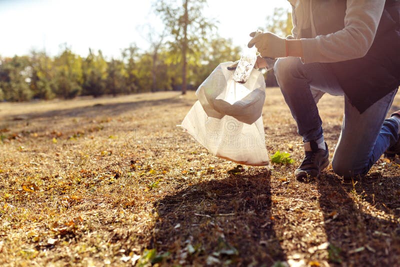 Young man picking up trash stock photo. Image of manual - 60604578 Young man picking up trash stock photo. Image of manual - 60604578